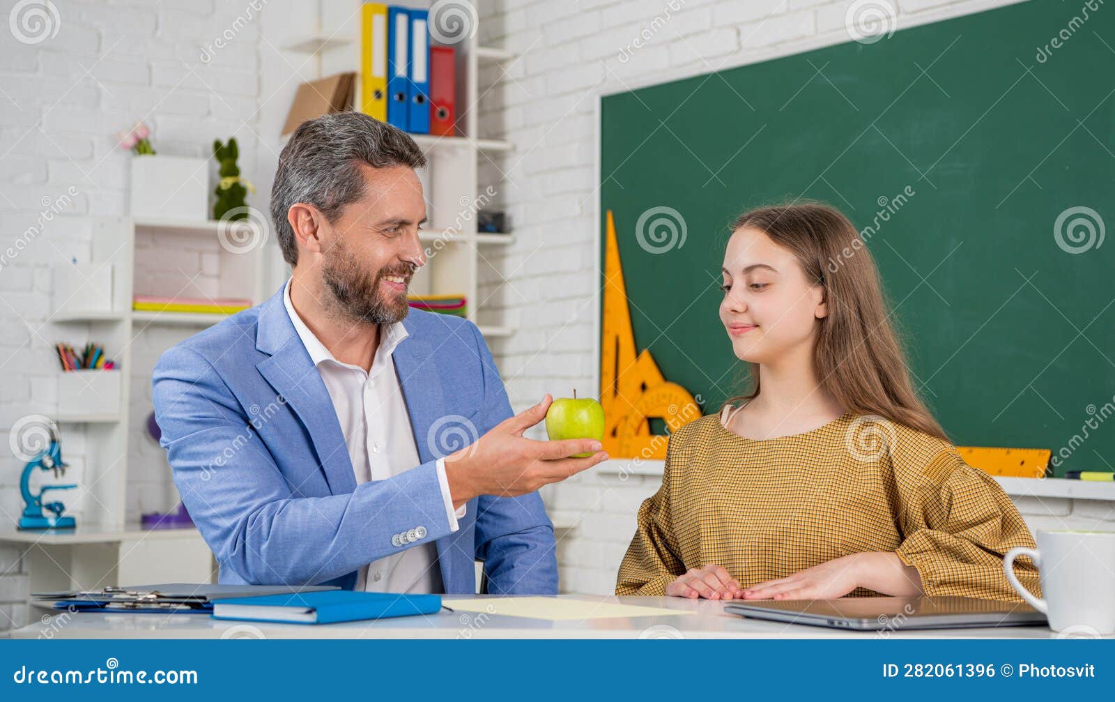 Happy Child in Classroom with Tutor Sharing Apple Stock Photo - Image ...