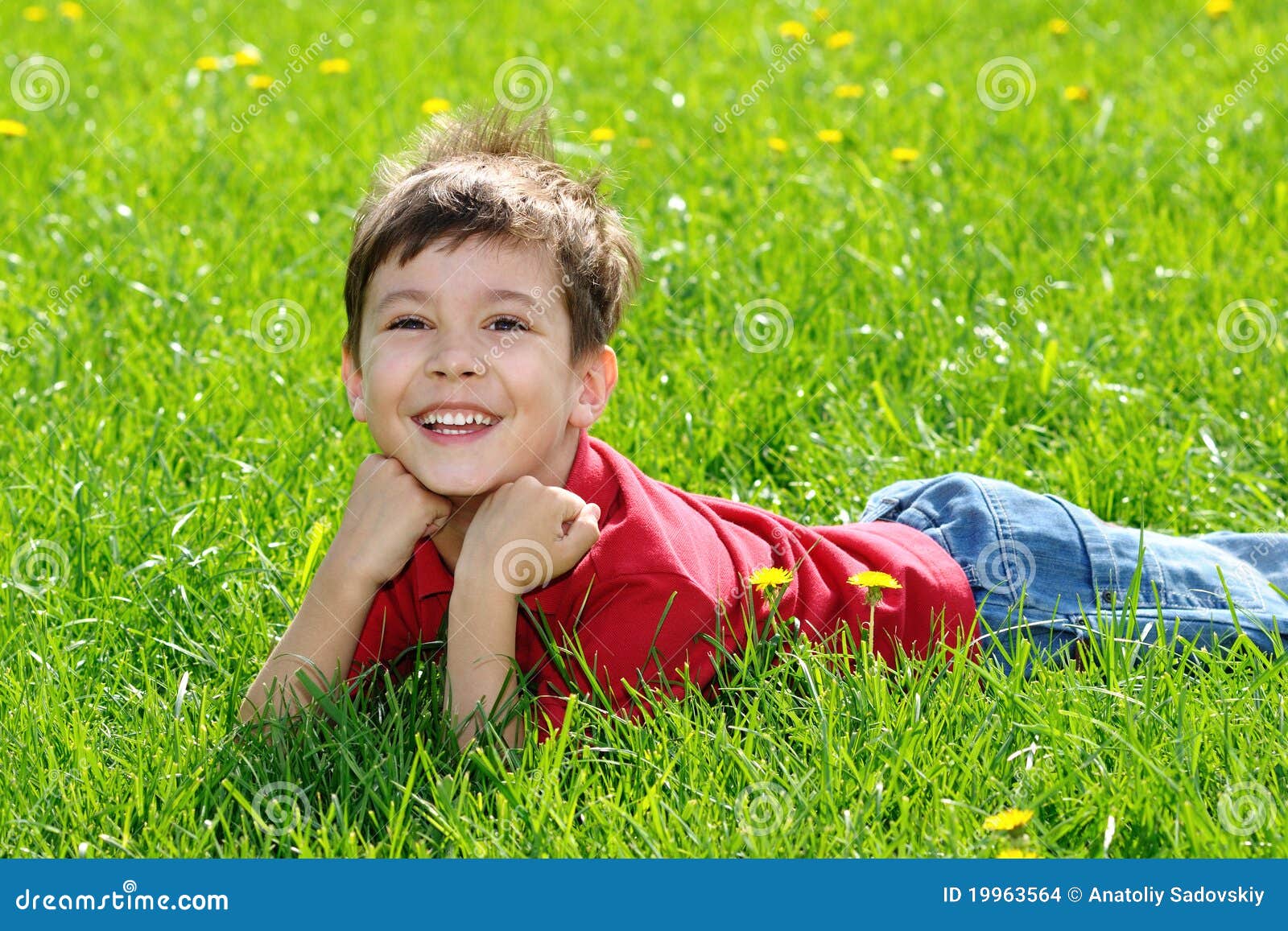 Happy child on green grass stock photo. Image of smiling - 19963564