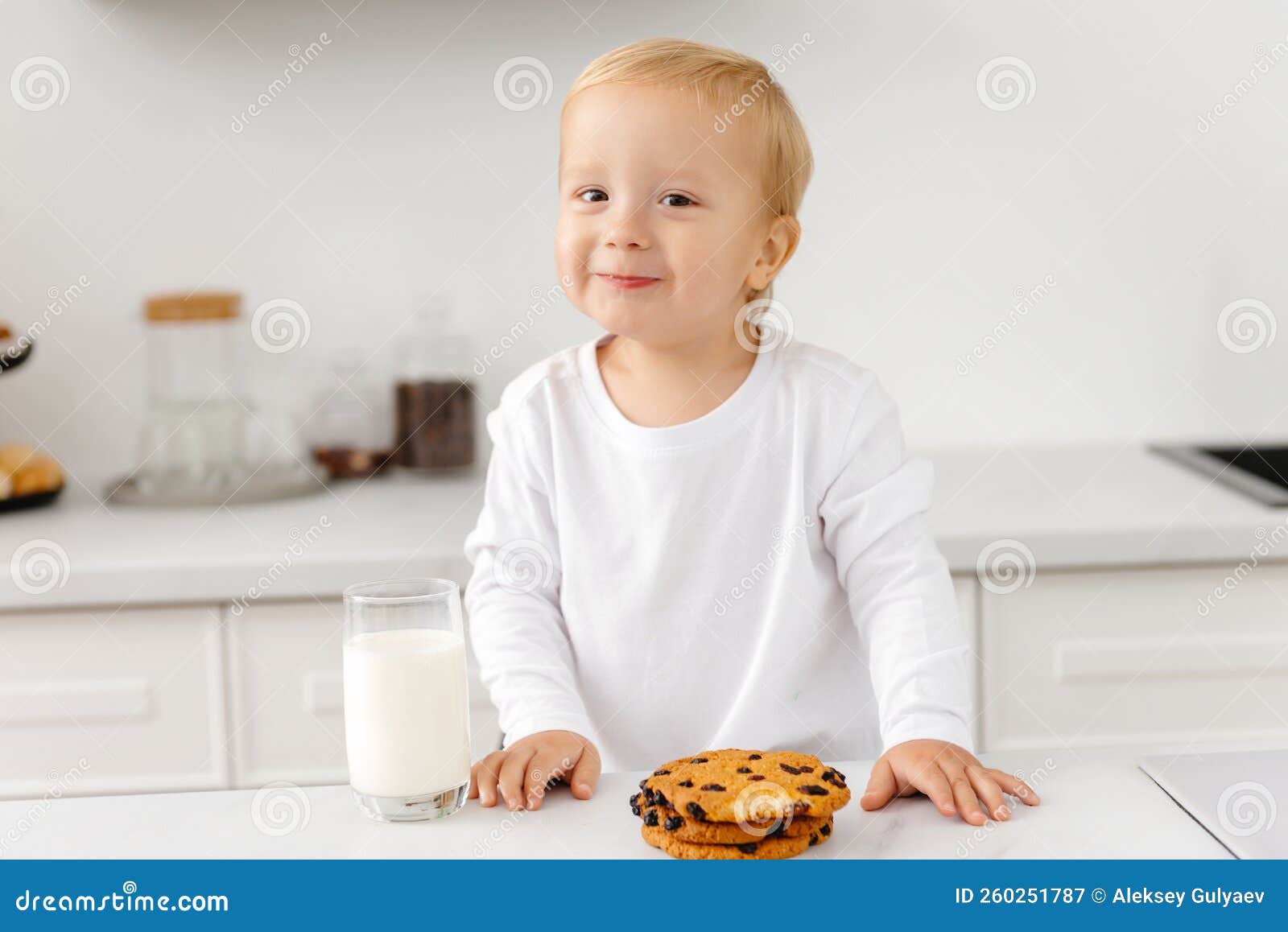 A Happy Child in the Kitchen. the Boy Smiles and Looks into the Camera ...
