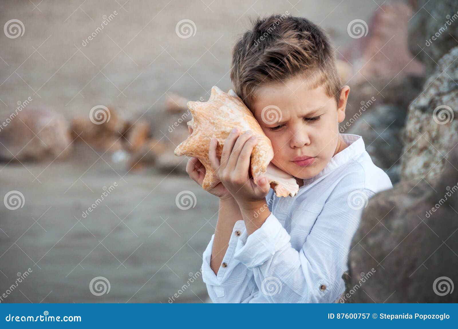 Happy Child Listen To Seashell. Vacations Concept. Stock Image - Image ...