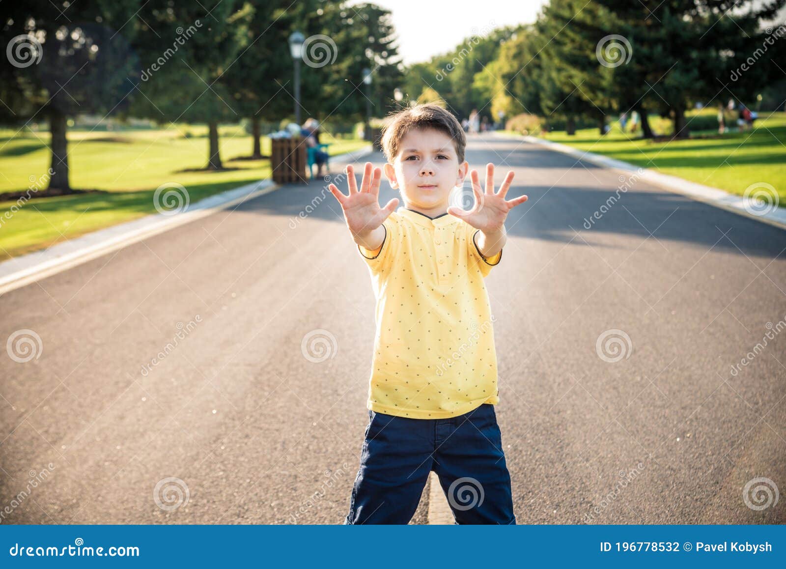Happy Child Making a Stop Sign with His Hand while Standing at the Road ...