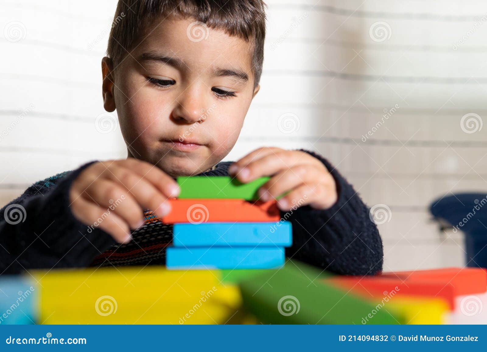 Happy Child Playing Building Blocks. Playing and Learning at Home ...