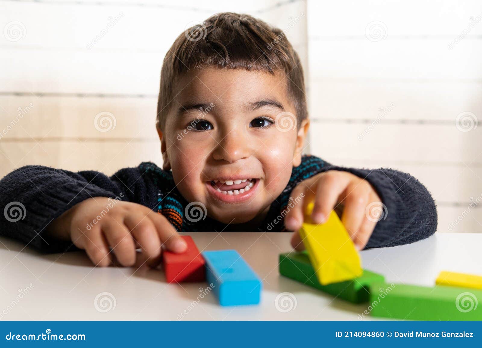 Happy Child Playing Building Blocks. Playing and Learning at Home ...