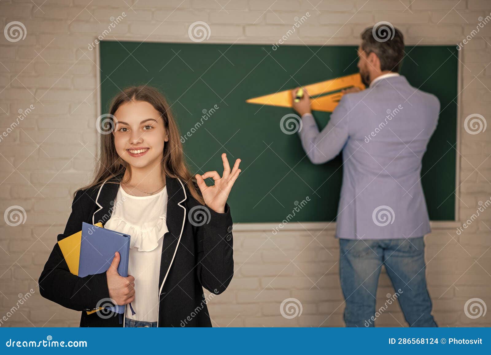 Happy Child Show Ok at Blackboard with Teacher. Selective Focus Stock ...