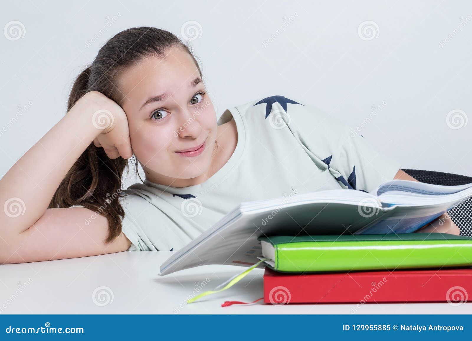 Happy Child Sitting at the Table Reading a Book. Stock Image - Image of ...