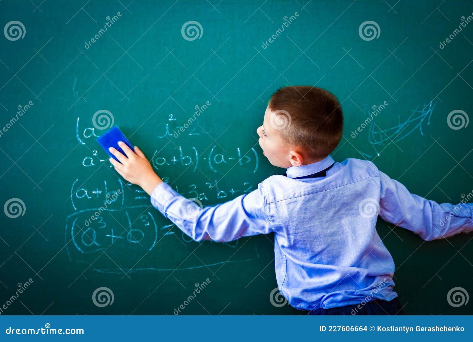 A Happy Child Child Standing at the Blackboard in the School Class at ...