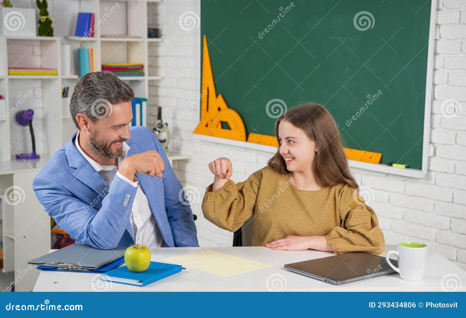 Happy Child Study in Classroom with Tutor. Fist To Fist Stock Photo ...