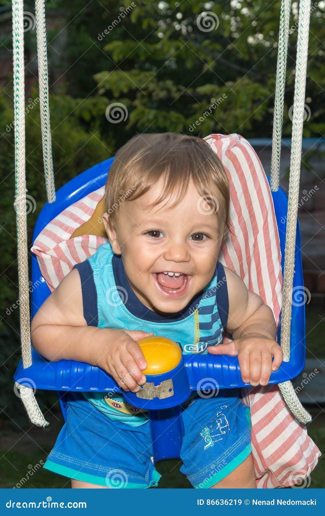 Happy child on swing stock image. Image of color, beauty - 86636219