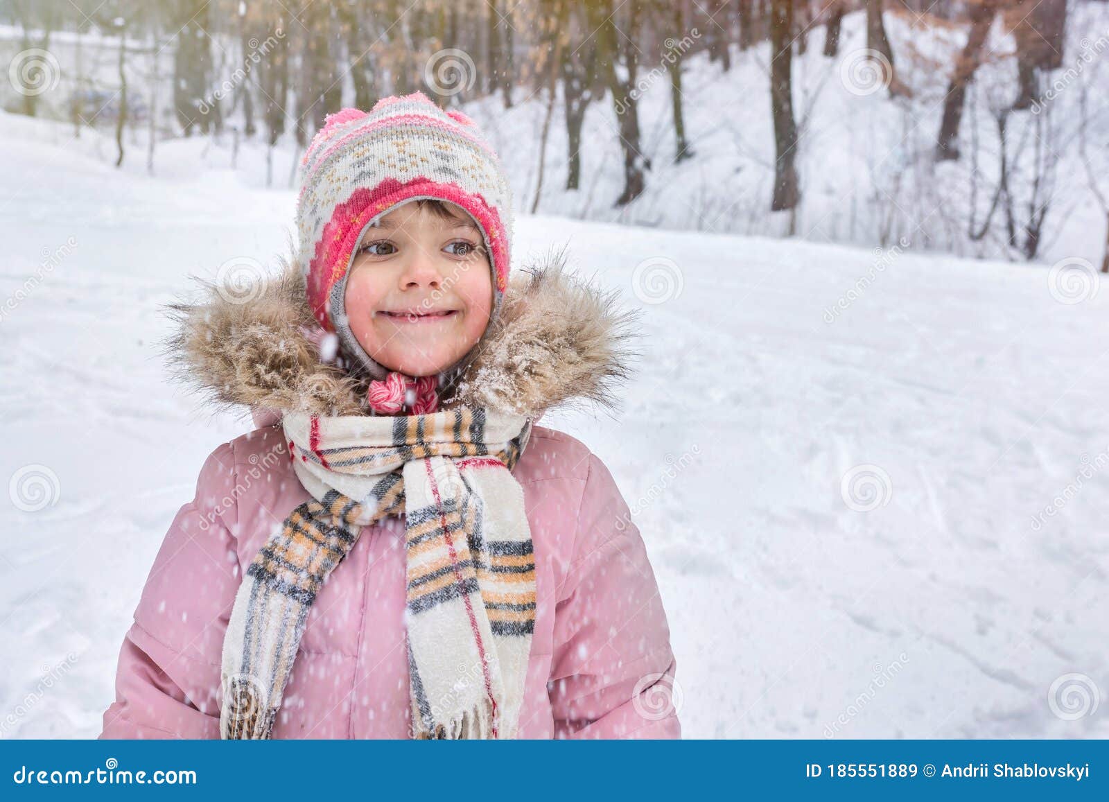 A Happy Child in Winter Cloths, Playing and Smiling during a Winter ...