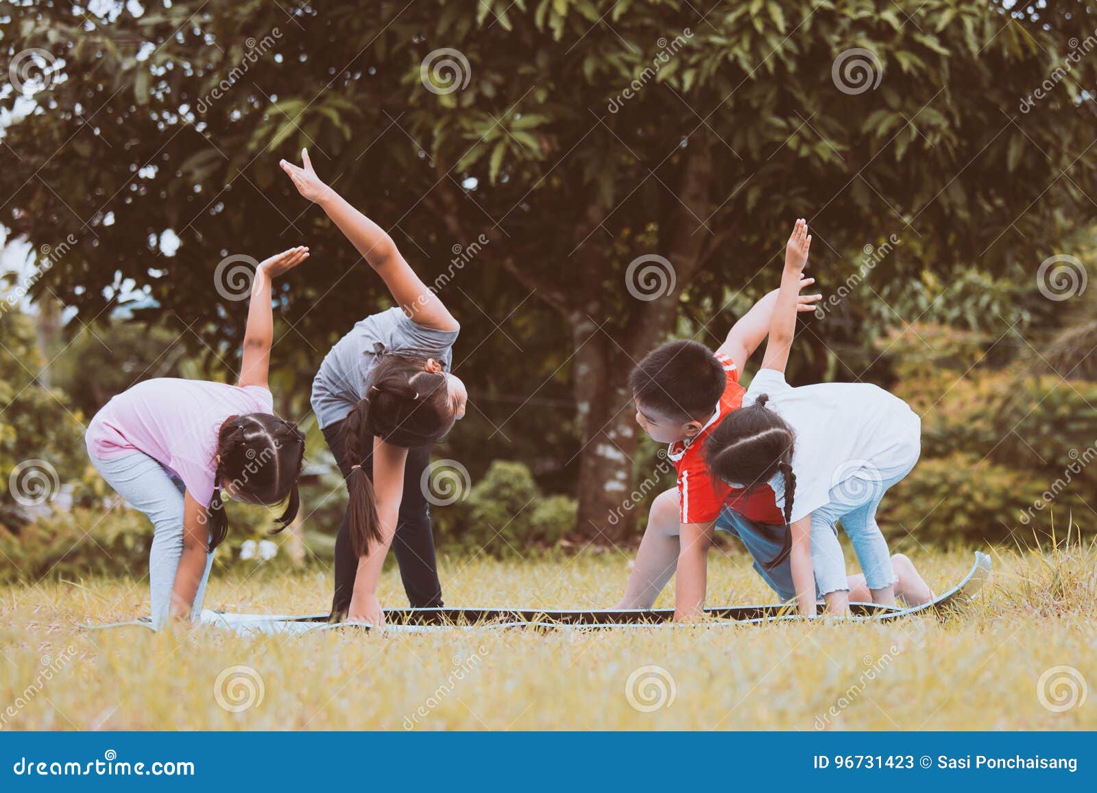 Happy Children Doing Exercise Together in the Park Stock Image - Image ...