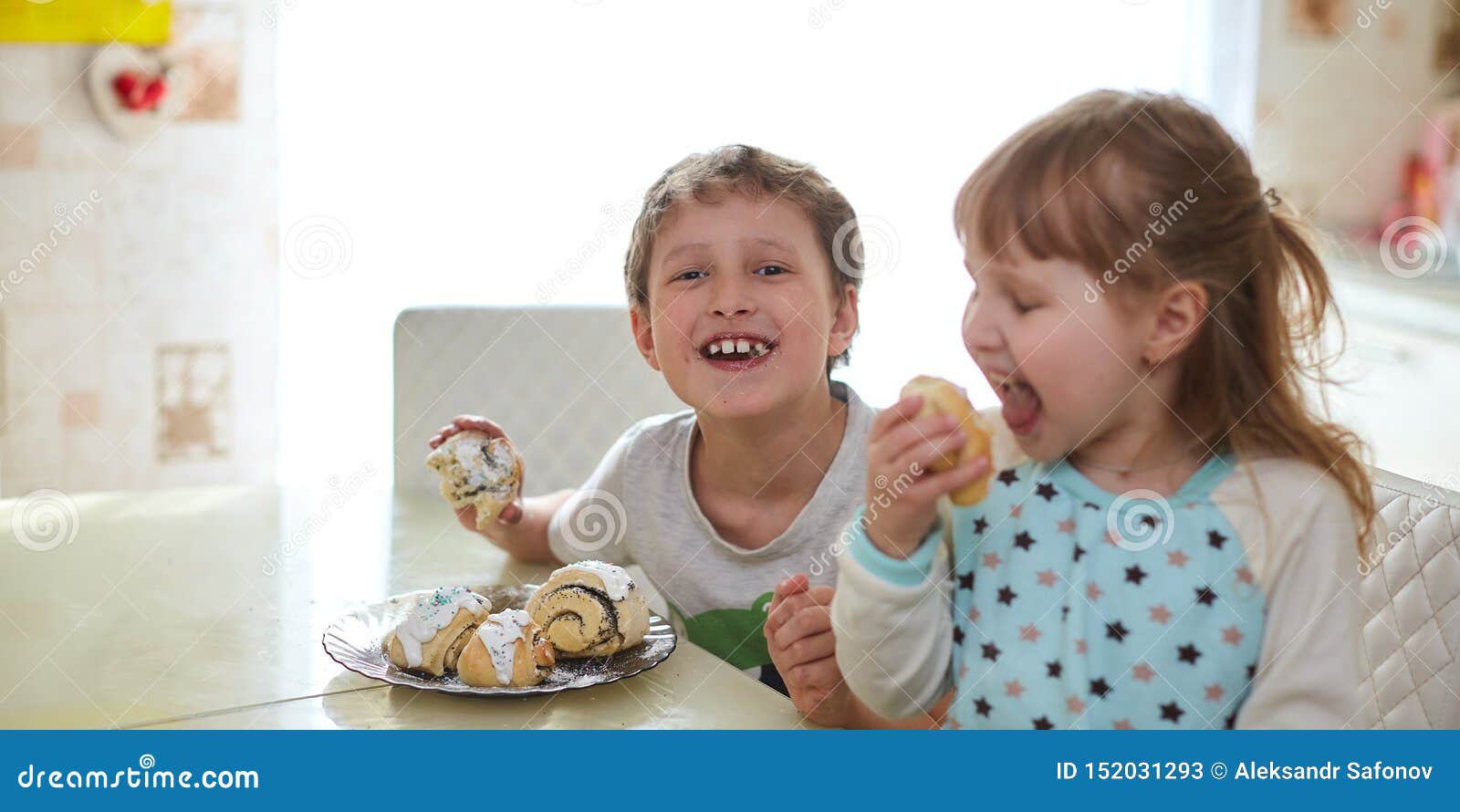 Happy Children Eat Pastries in the Bright Kitchen Stock Image - Image ...