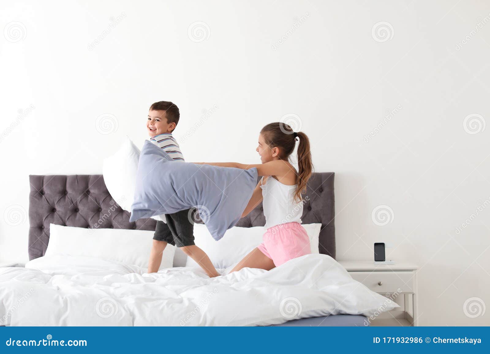 Happy Children Having Pillow Fight Stock Photo - Image of cute, home ...
