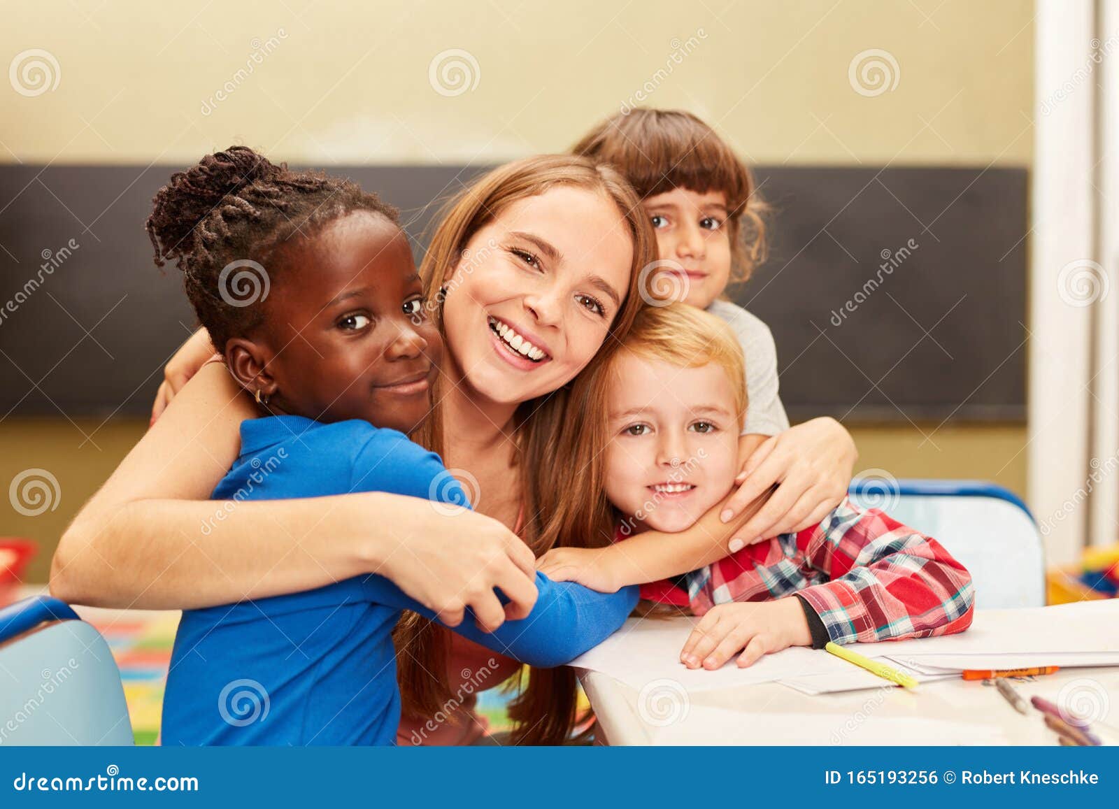 Happy Children Hug Their Educator Stock Photo - Image of childhood ...