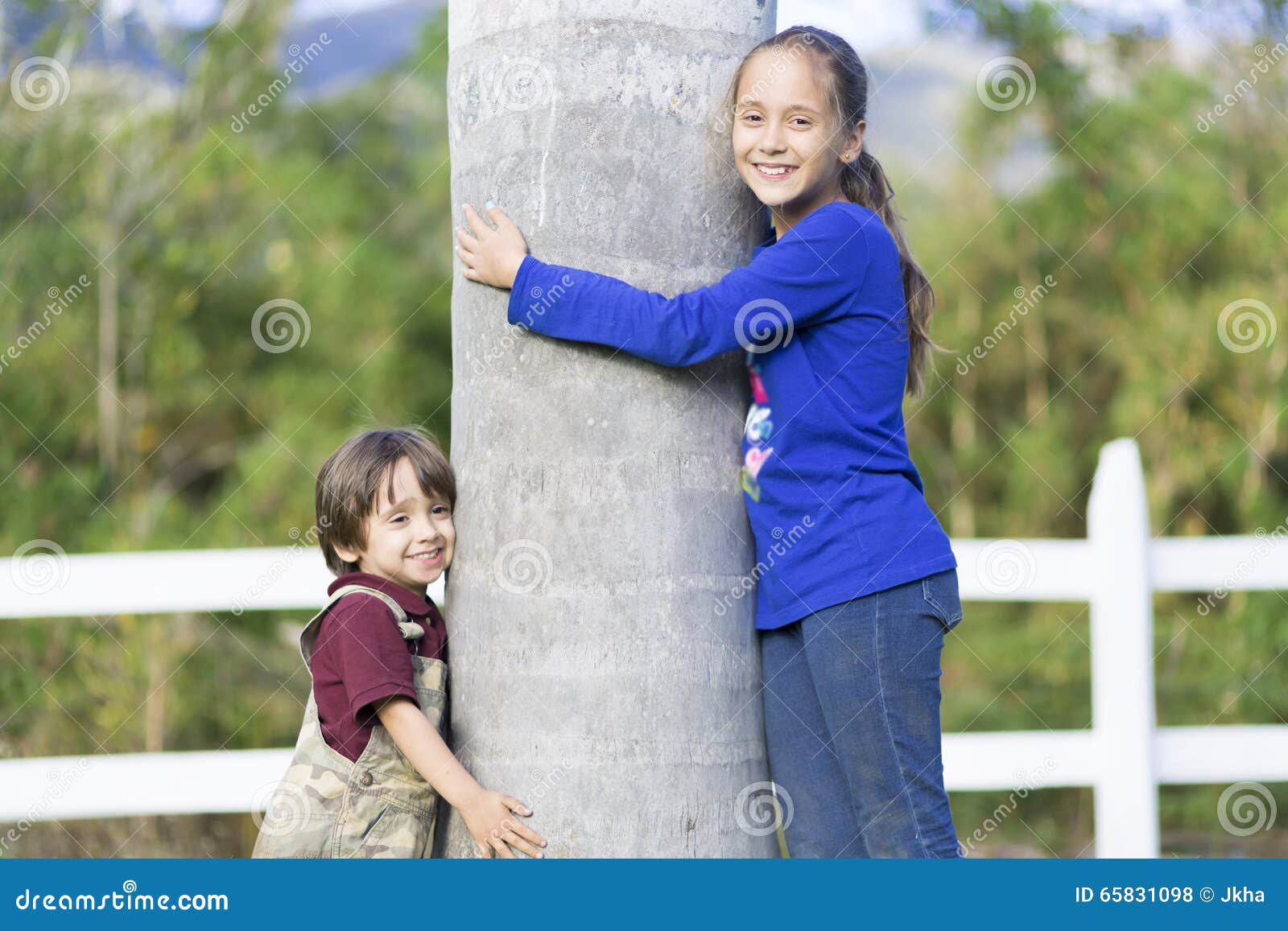 Happy Children Hugging a Tree Stock Photo - Image of ecology, kids ...