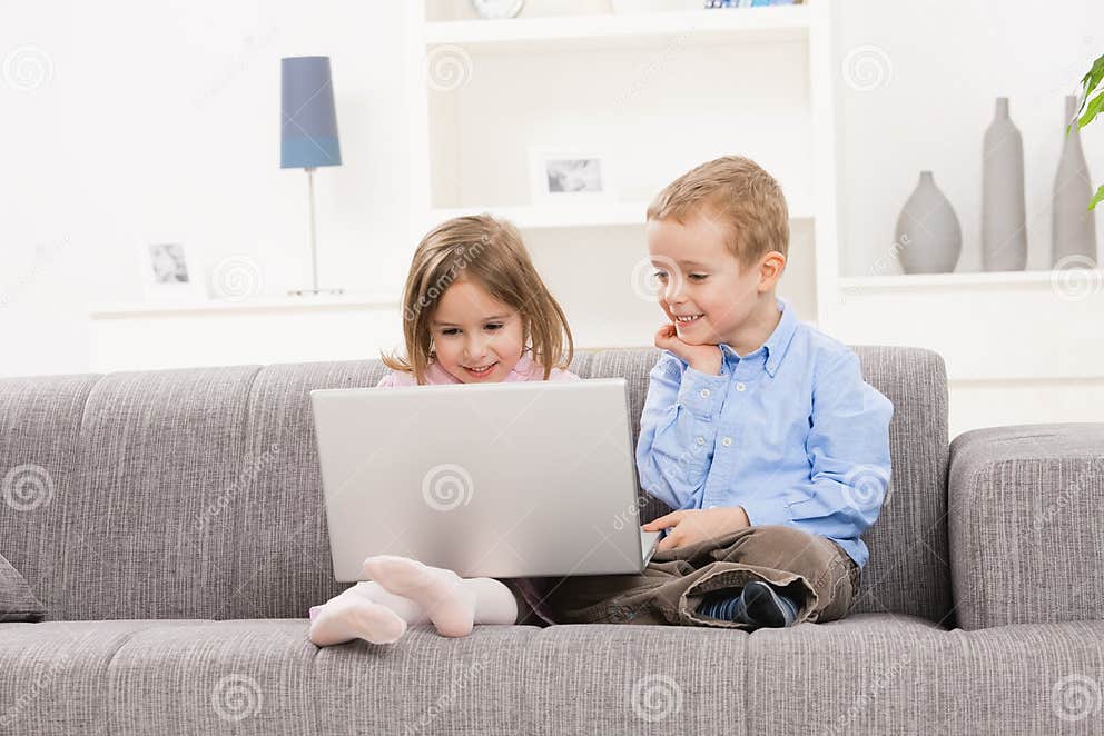 Happy children with laptop stock photo. Image of interior - 9797280
