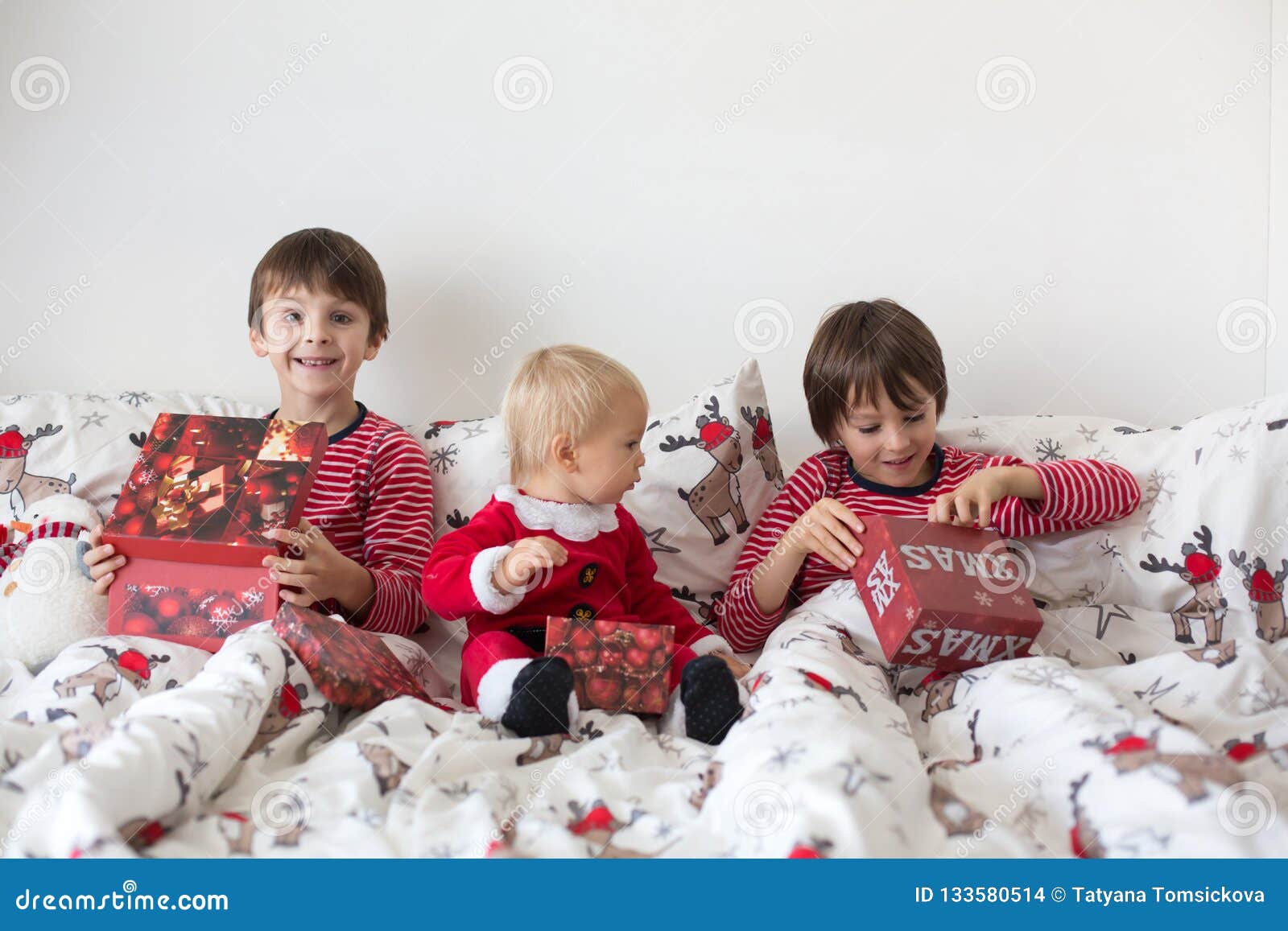 Happy Children, Opening Christmas Presents in Bed Stock Photo - Image ... Happy Children, Opening Christmas Presents in Bed Stock Photo - Image ...