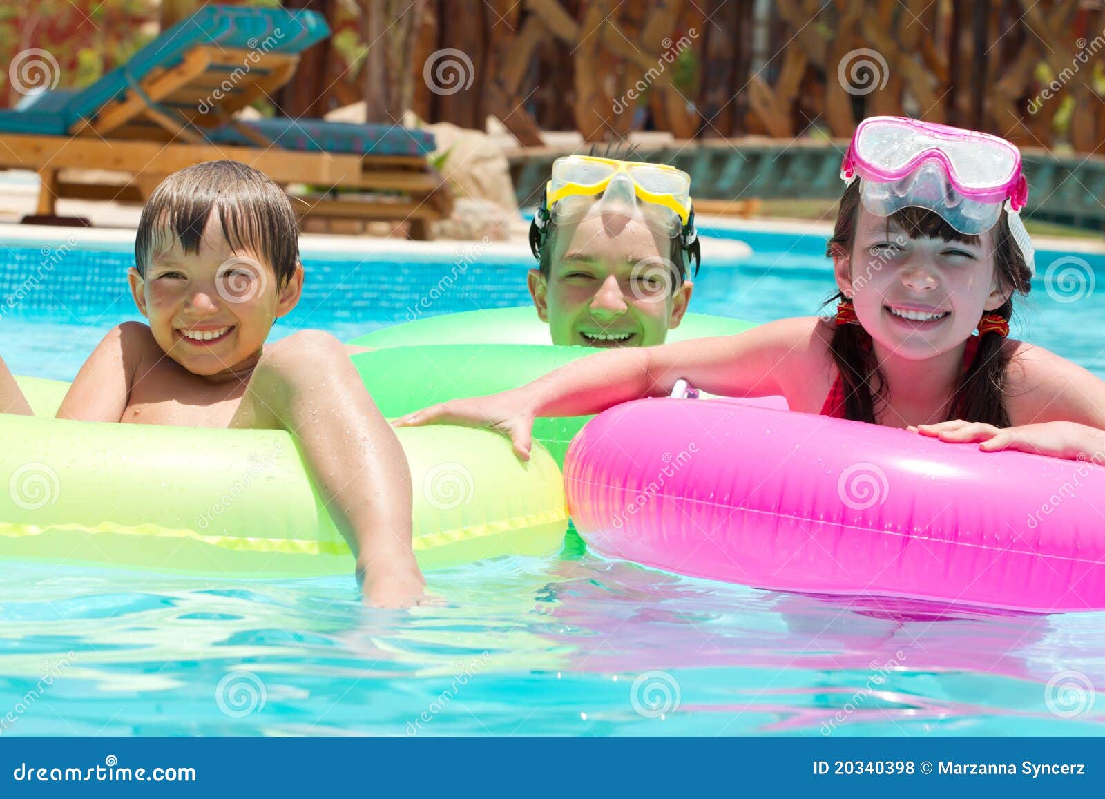 Happy children in pool stock photo. Image of colourful - 20340398