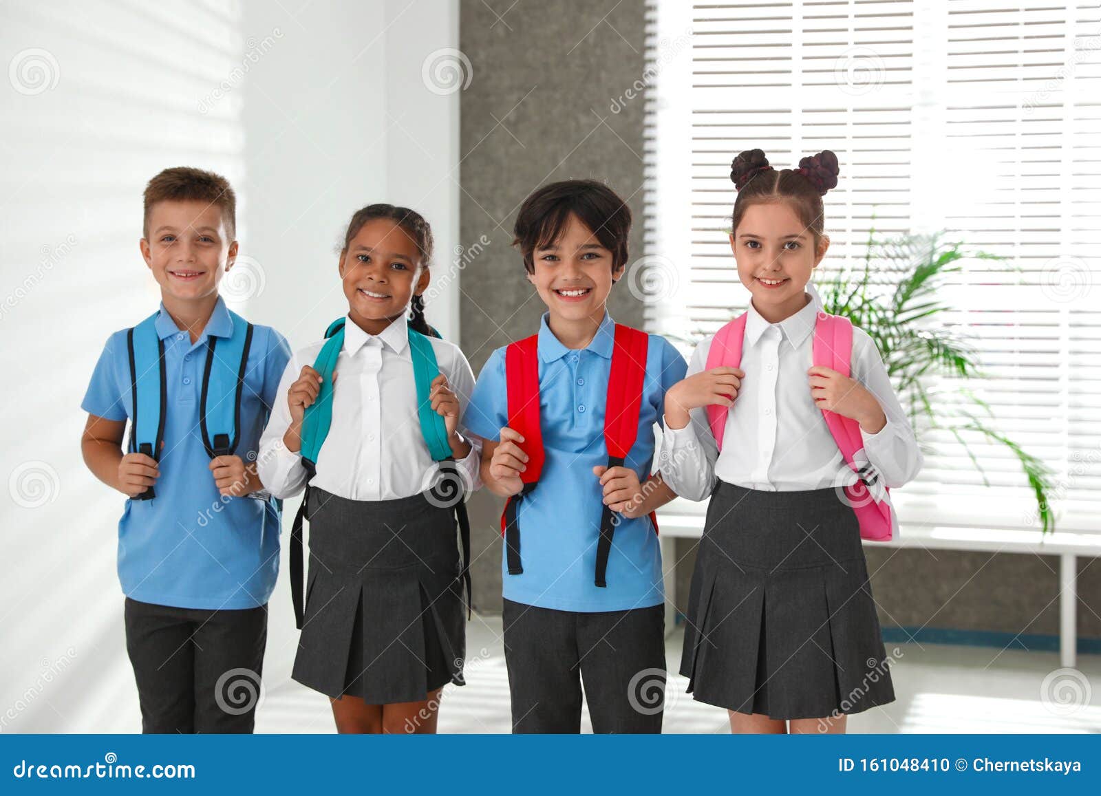 Happy Children in School Uniform with Backpacks Stock Photo - Image of ...