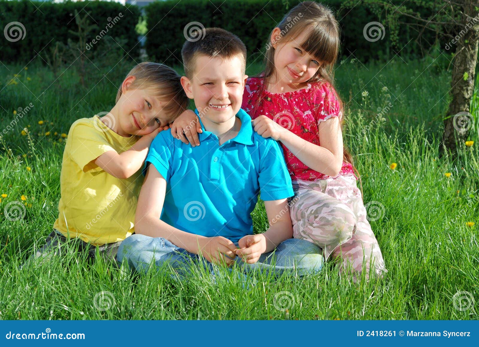 Happy Children Seated in Grass Stock Image - Image of love, girl: 2418261