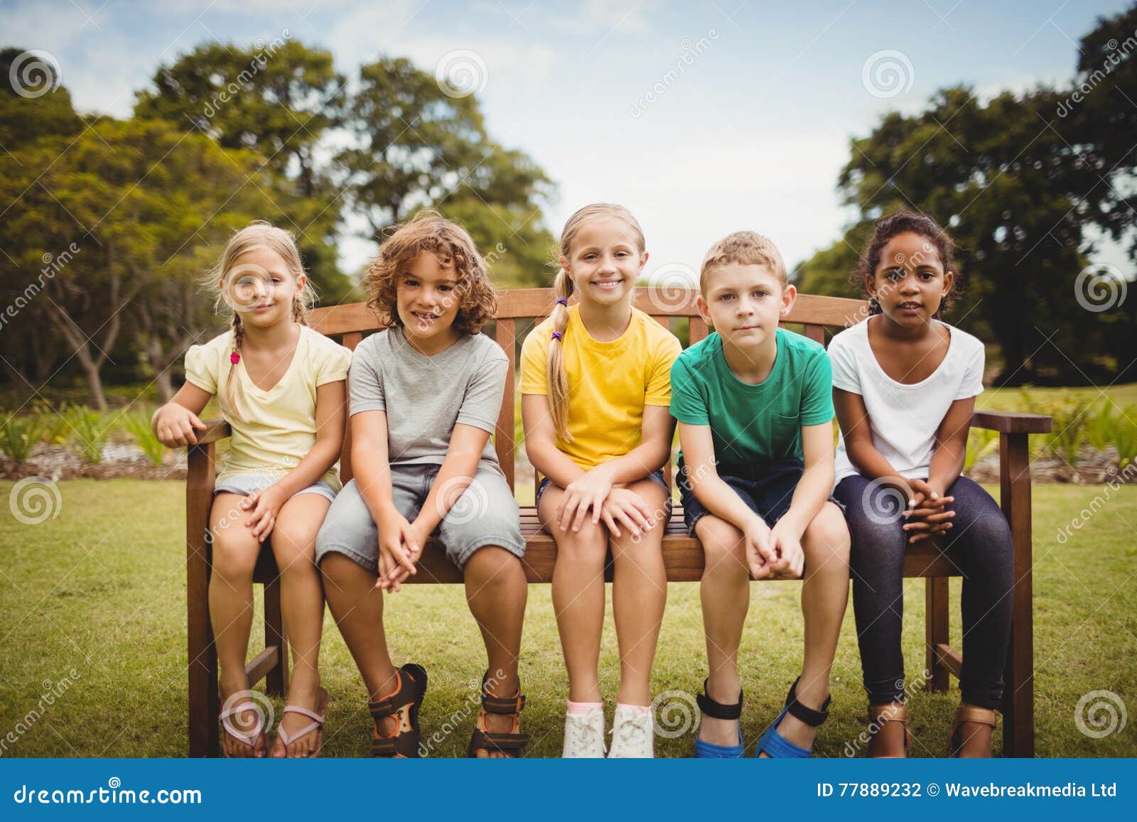Happy Children Sitting on a Bench Stock Photo - Image of clothing ...