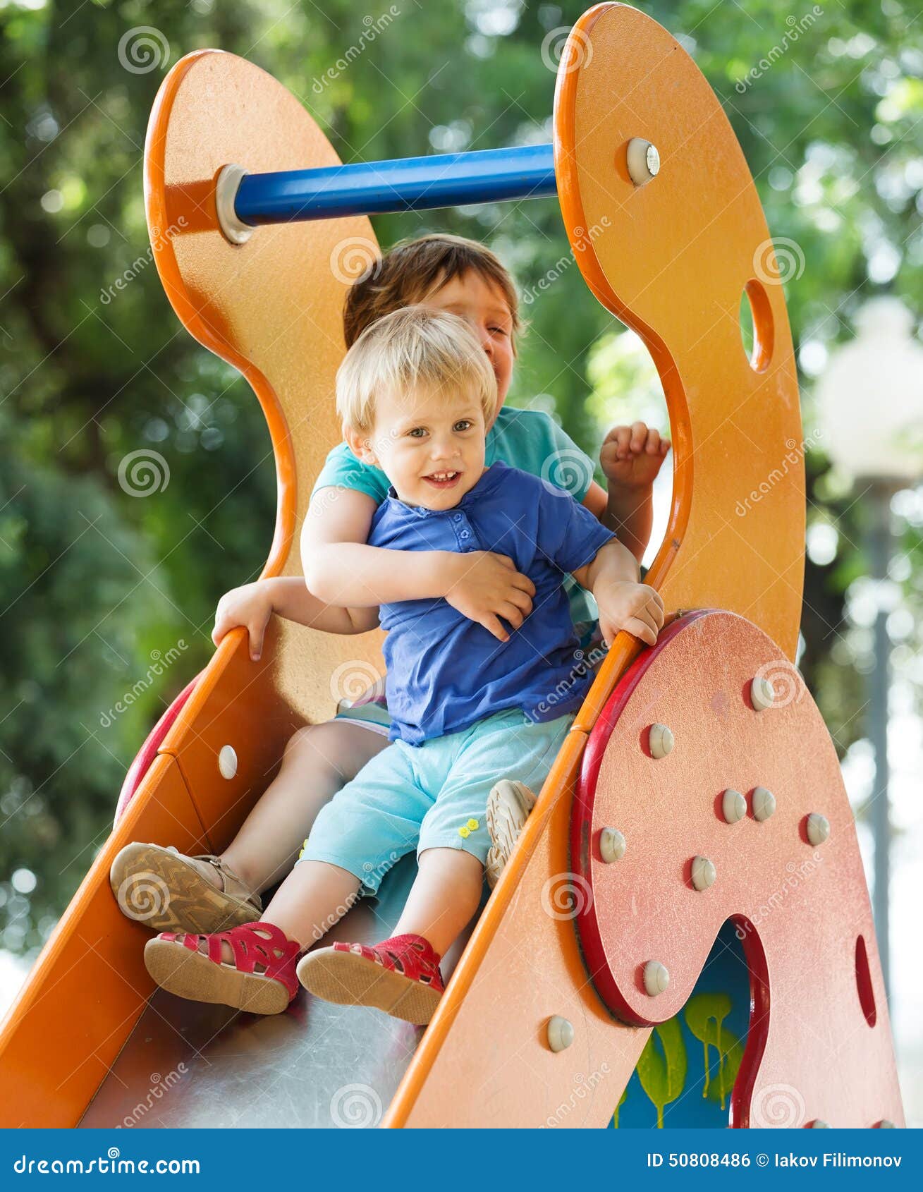 Happy children on slide stock photo. Image of park, jacket - 50808486