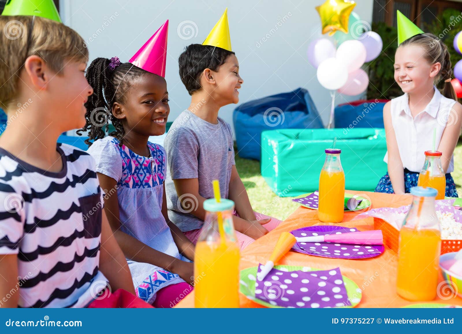 Happy Children Talking at Table Stock Image - Image of horn, bottle ...