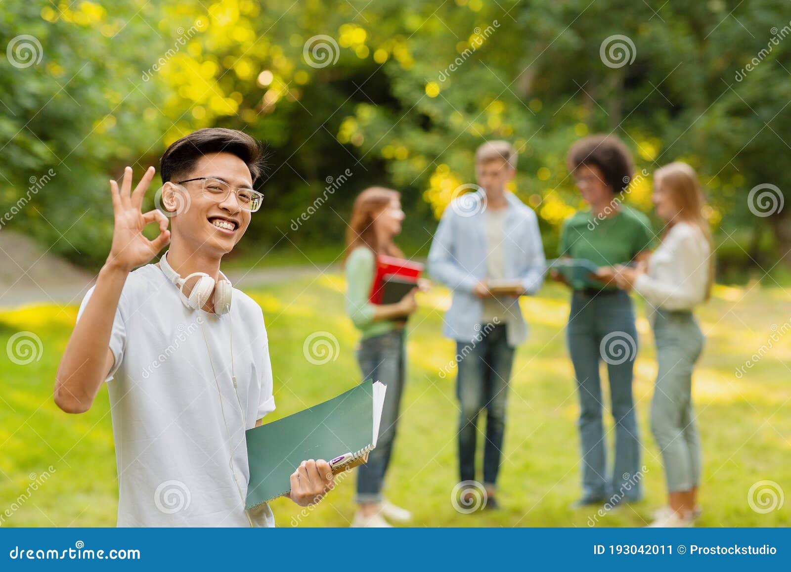 Happy Chinese Student Guy Gesturing Ok while Posing Outdoors at Campus ...