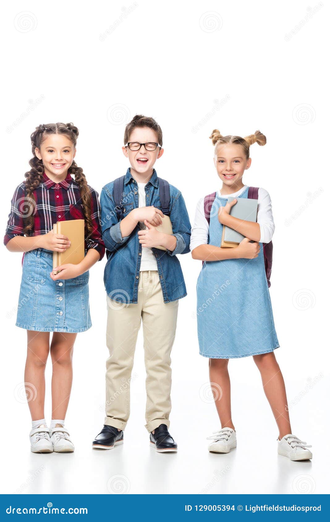 Happy Classmates Holding Books and Looking at Camera Stock Photo ...