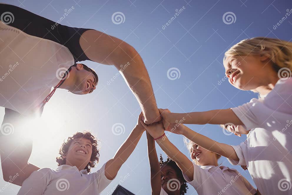 Happy Coach and Schoolkids Forming Handstack Stock Photo - Image of ...