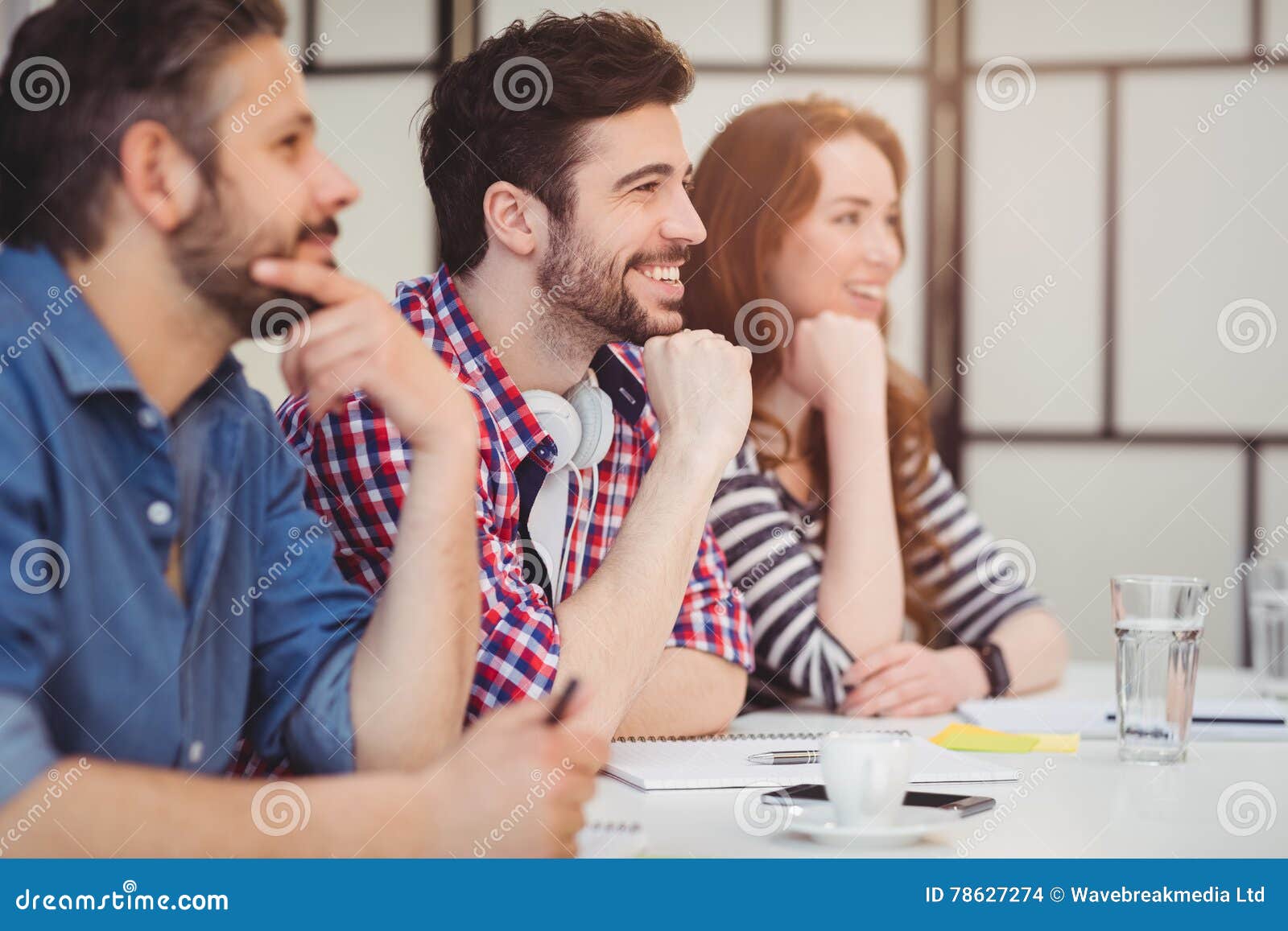 Happy Colleagues Sitting at Desk in Creative Office Stock Photo - Image ...
