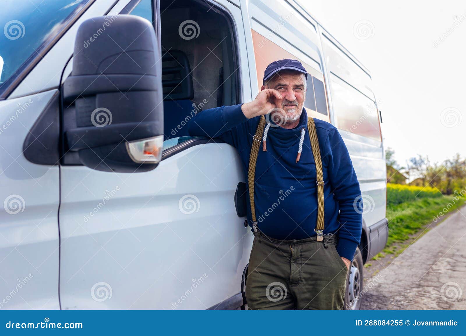 Confident Male Driver Standing in Front on His Van and Looking at ...