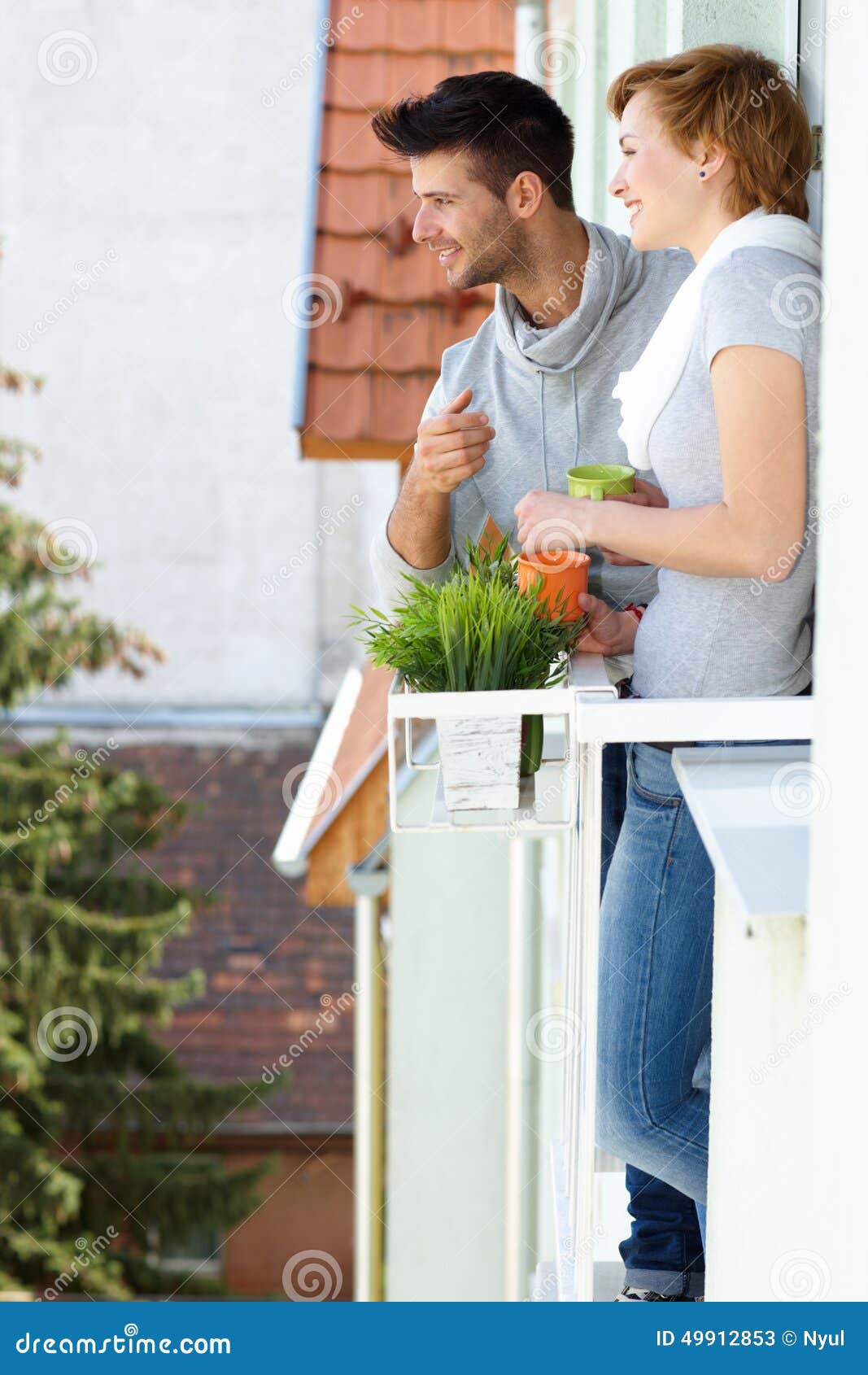 Happy couple at balcony stock image. Image of clothing - 49912853