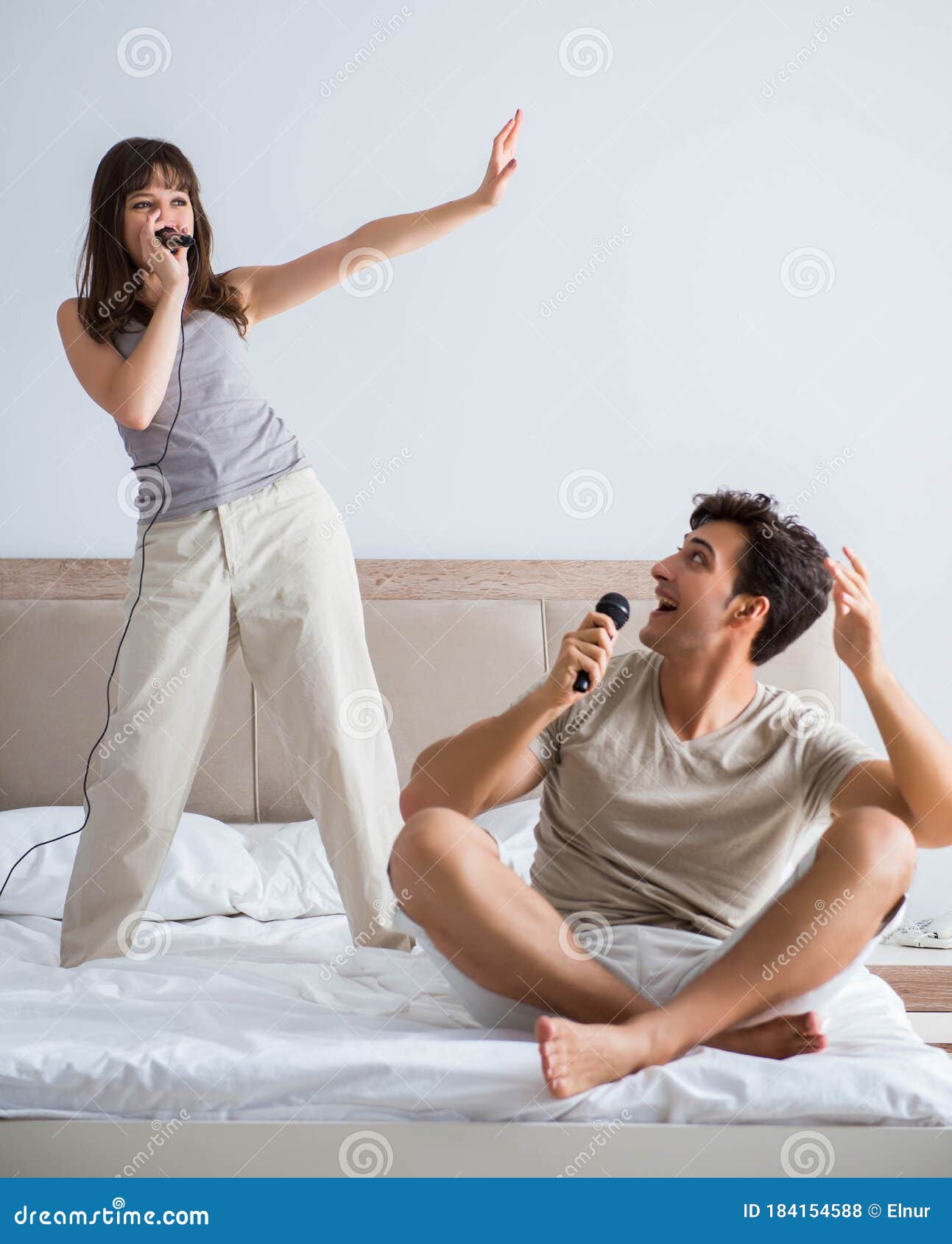 Happy couple in the bed stock photo. Image of love, excited - 184154588