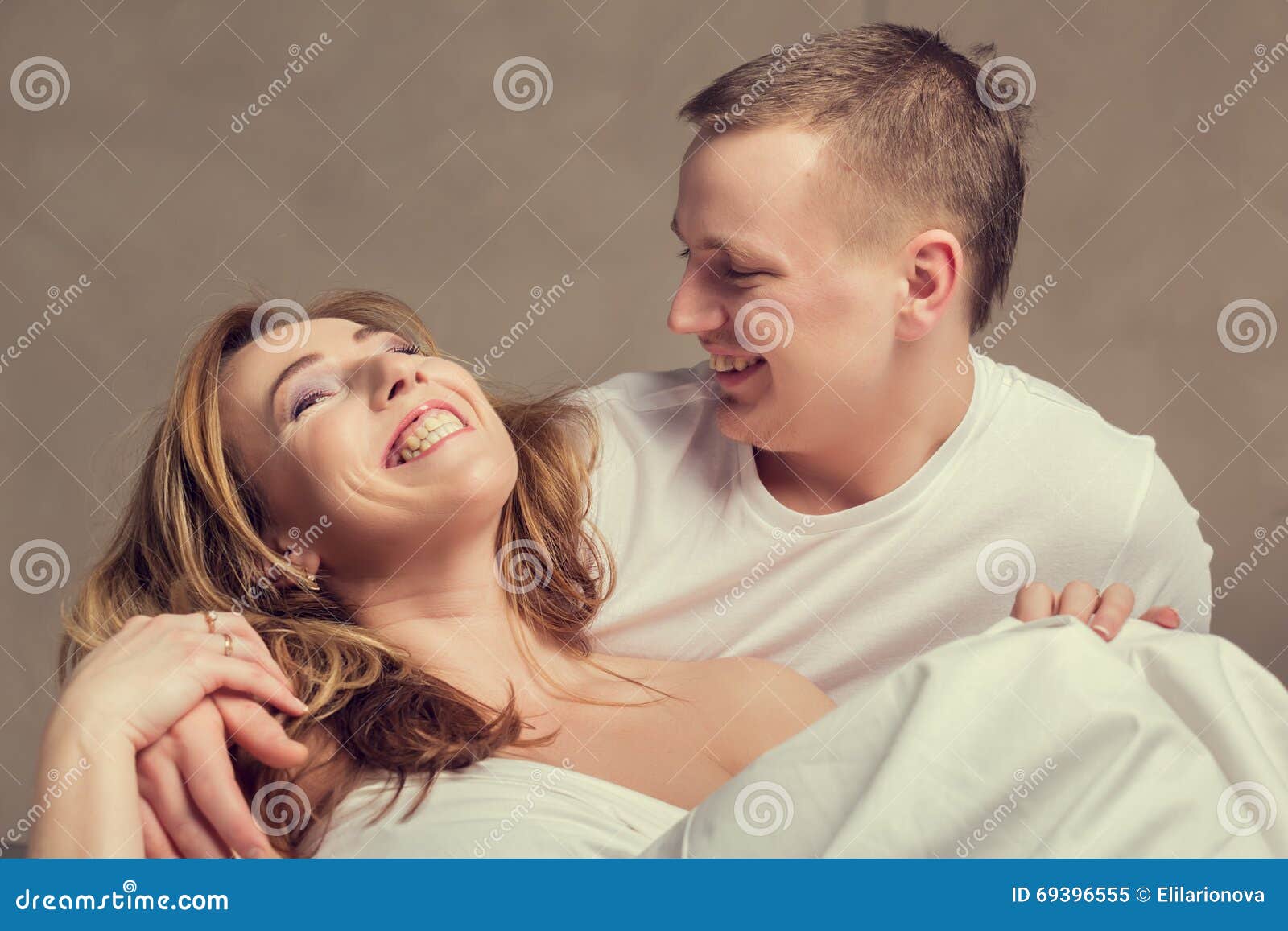 Happy couple in a bedroom. stock image. Image of love - 69396555