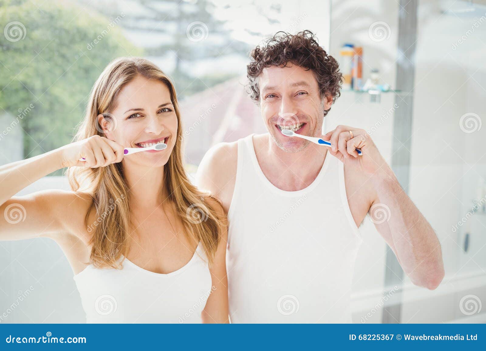 Happy Couple Brushing Teeth Stock Image - Image of homey, beautiful ...