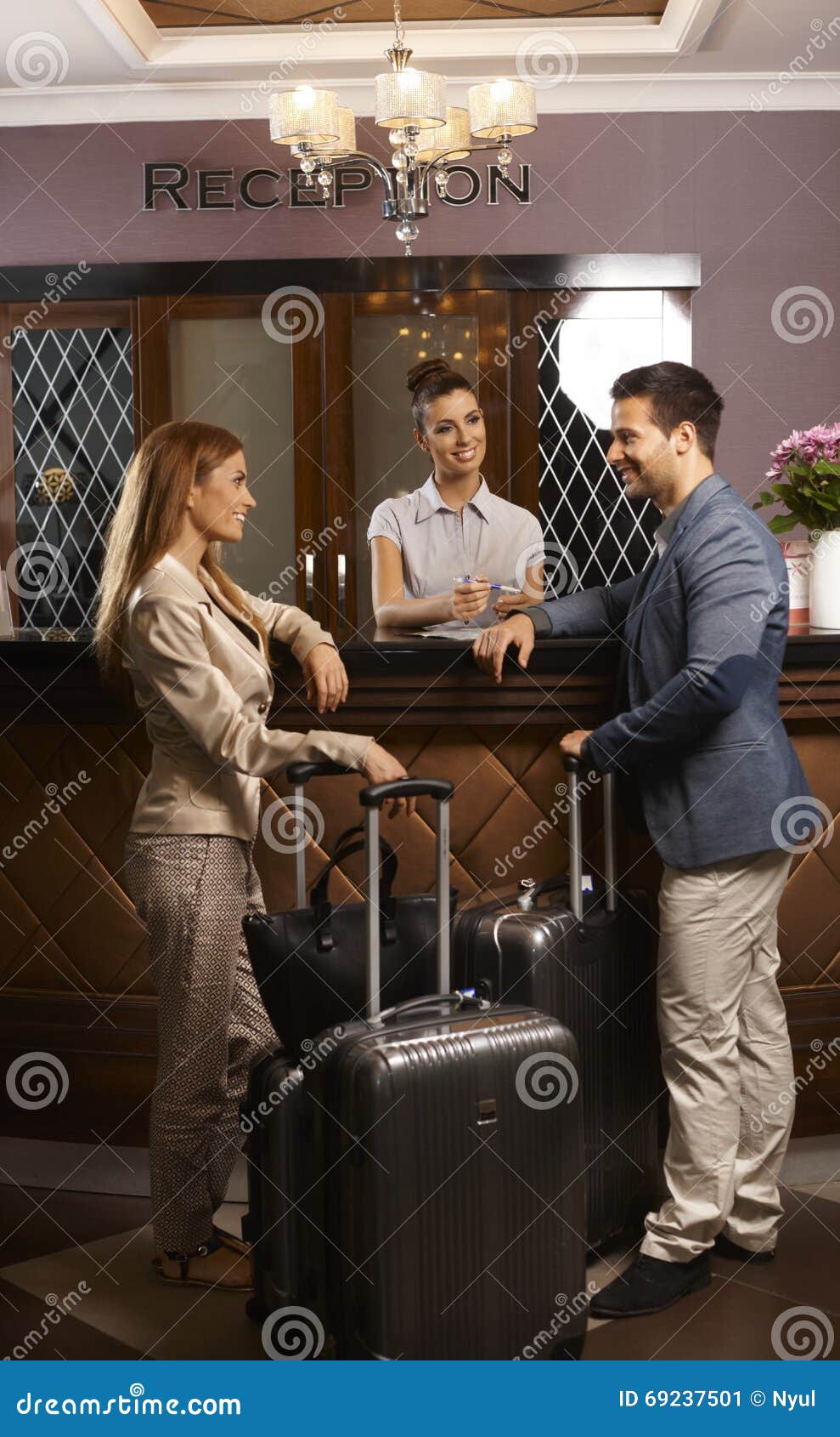 Happy Couple Checking in at Hotel Reception Stock Image - Image of ...