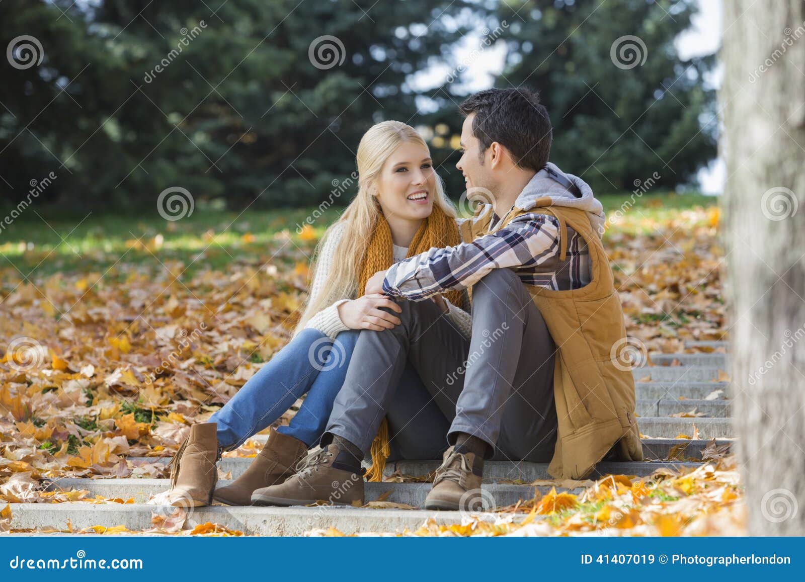 Happy Couple Communicating on Steps in Park Stock Image - Image of ...
