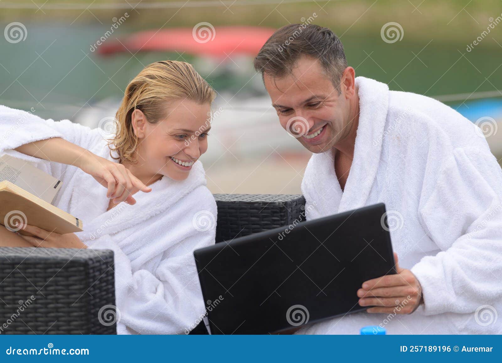 Happy Couple with Computer at Swimming Pool Lounge on Terrace Stock ...