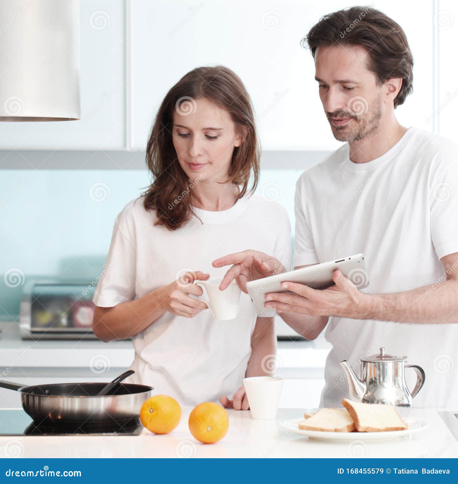 Couple cooking breakfast stock image. Image of lifestyle - 168455579