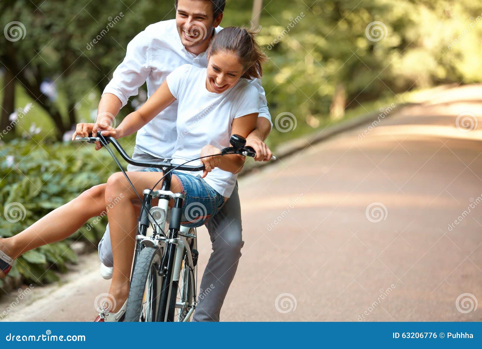 Happy Couple Cycling in the Summer Park Stock Photo - Image of ...