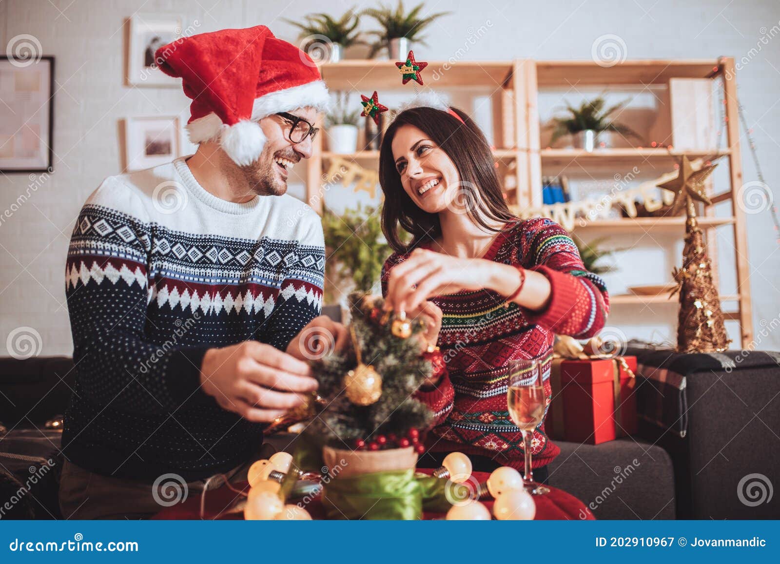 Couple Decorating Christmas Tree in Their Home Stock Image - Image of ...