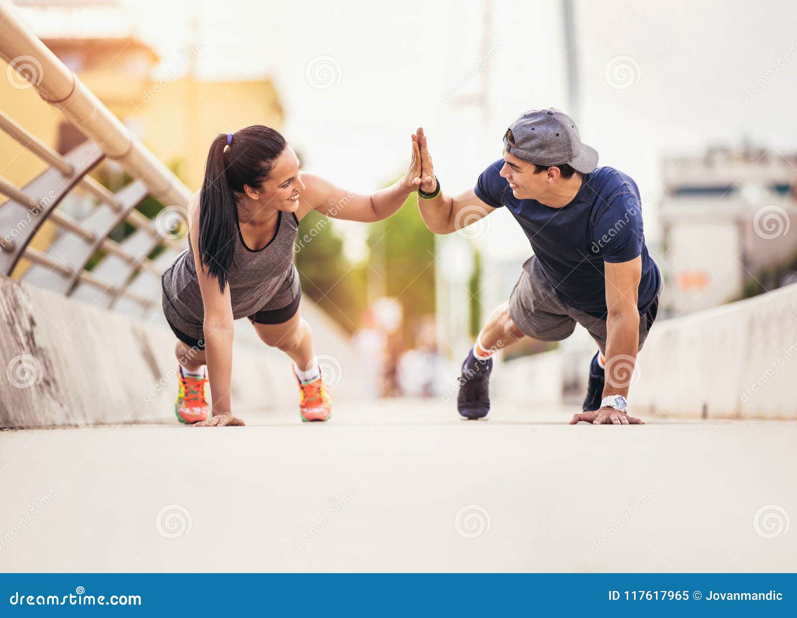 Couple Doing Push-ups Outdoors on the Bridge Stock Image - Image of ...
