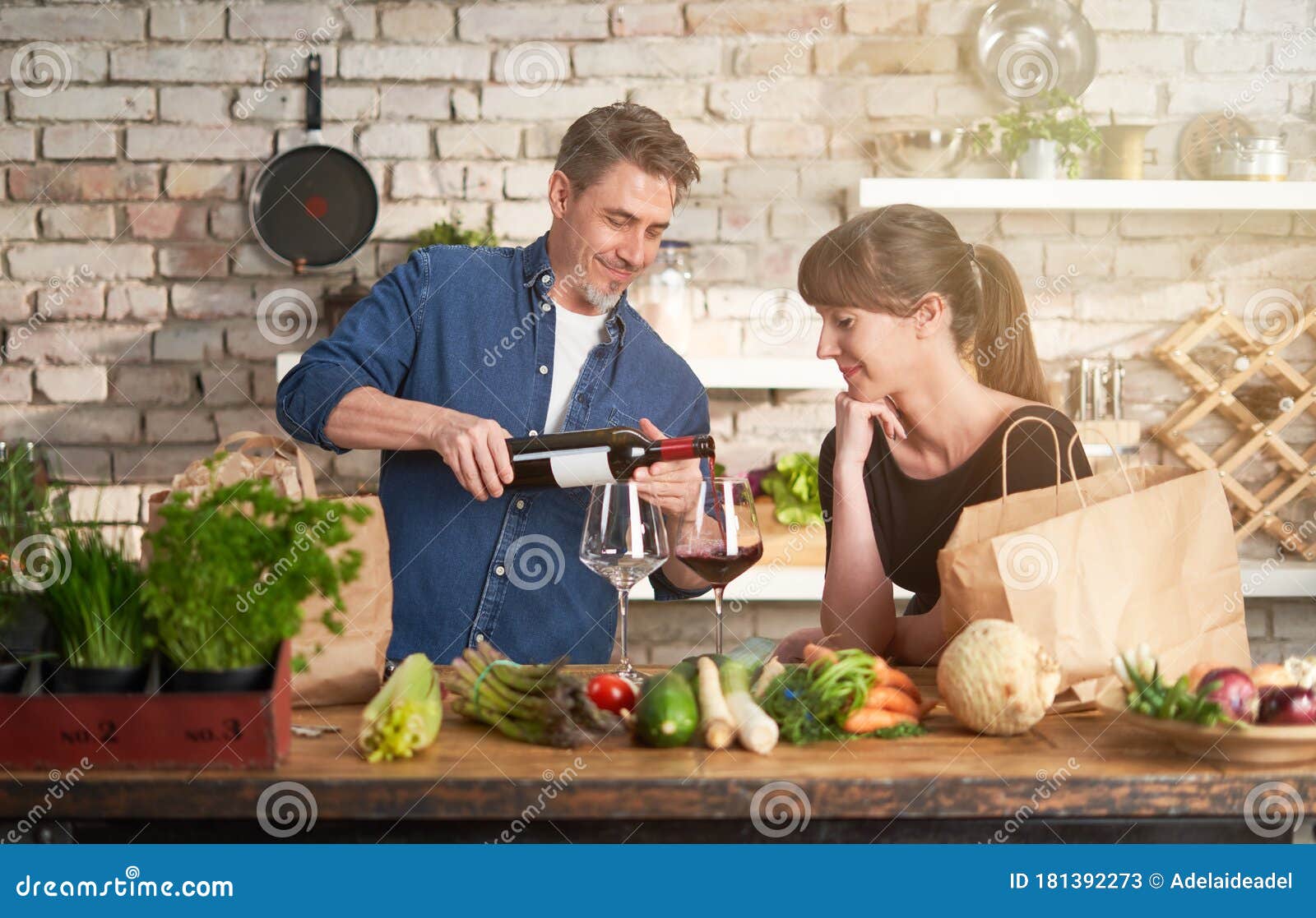 Happy Couple Drinking Wine at Home while Cooking in the Kitchen Stock ...