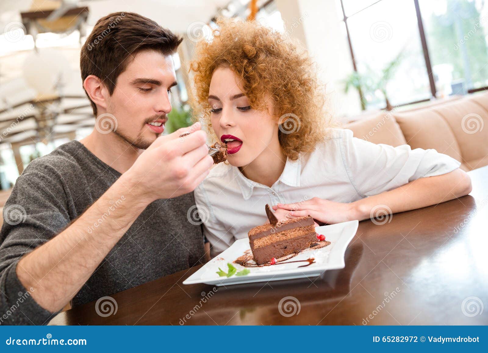 Happy Couple Eating Cake in Restaurant Stock Photo - Image of couple ...