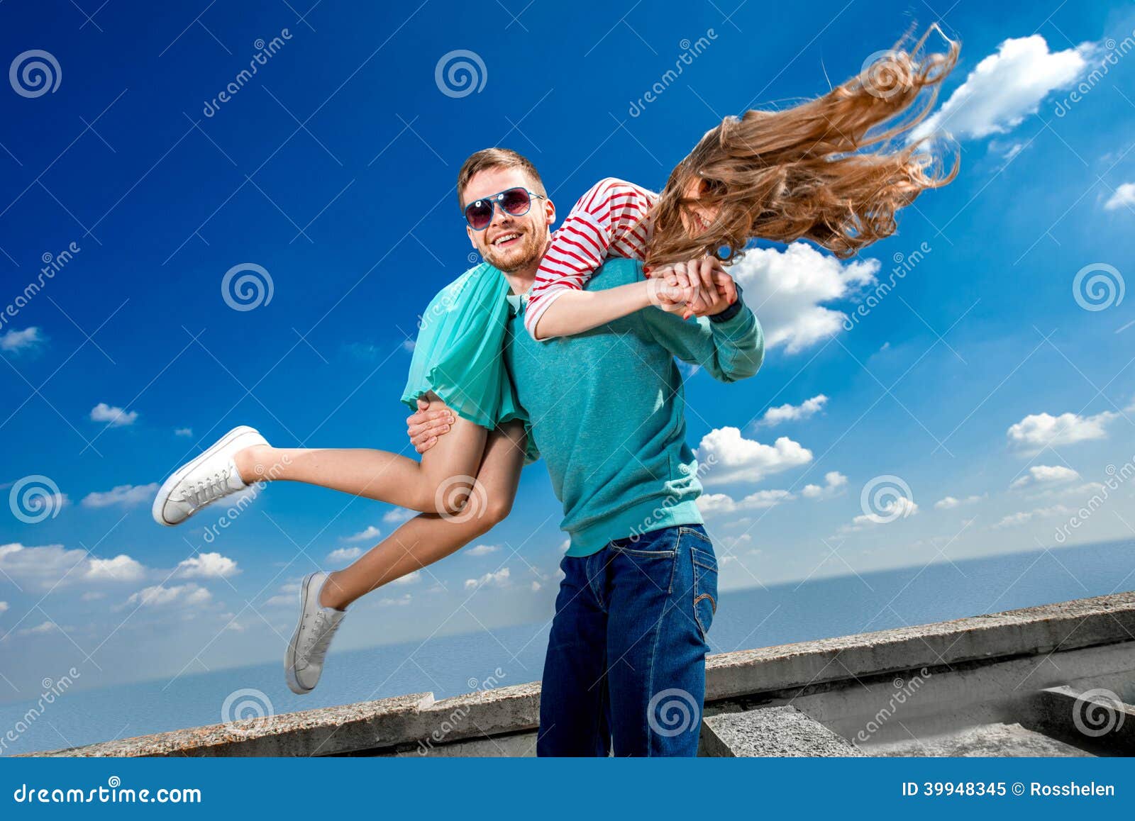 Happy Couple Embracing and Having Fun Under the Blue Sky Stock Image ...