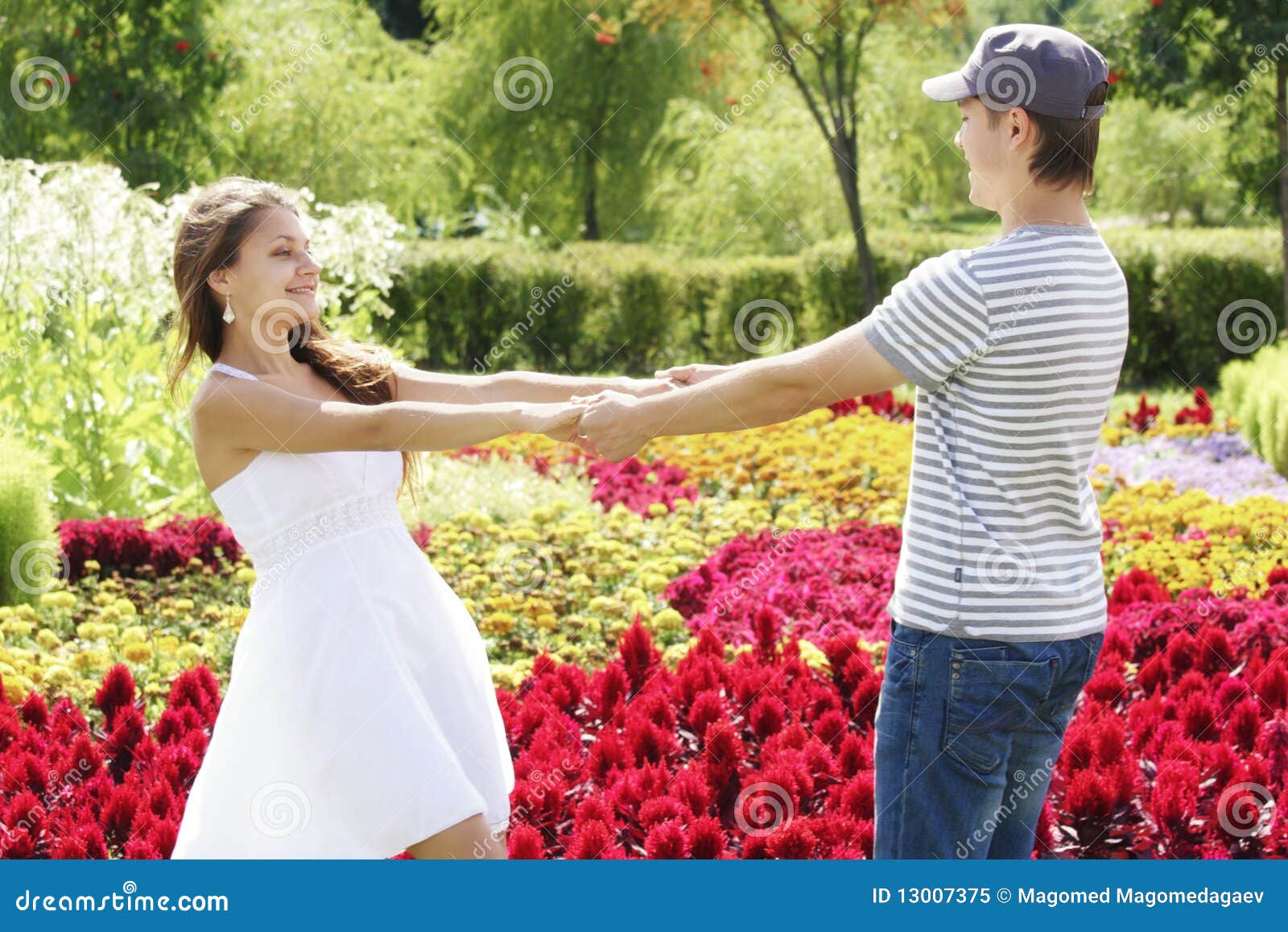 Happy couple among flowers stock image. Image of horizontal - 13007375