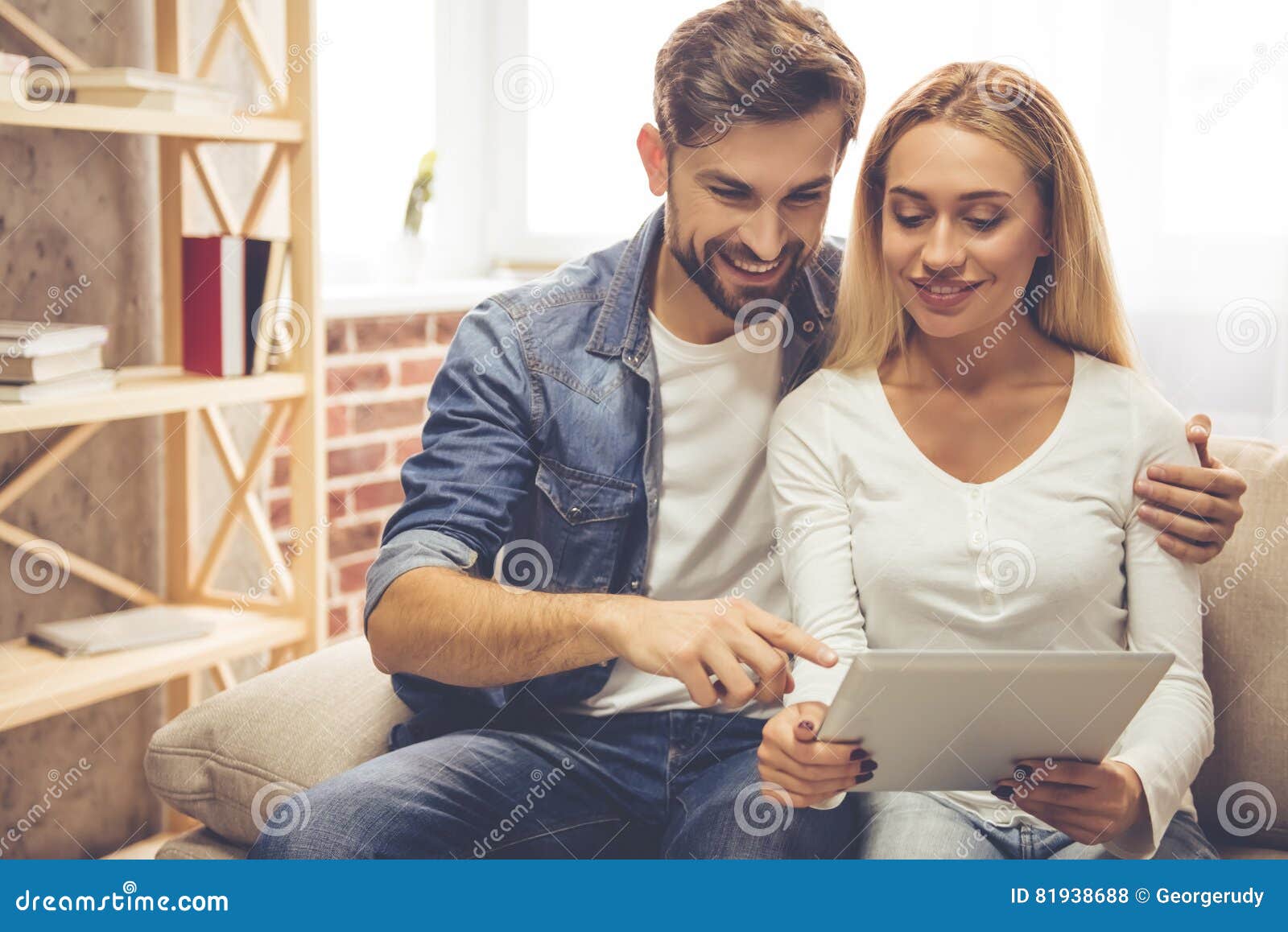 Happy couple with gadget stock photo. Image of caucasian - 81938688