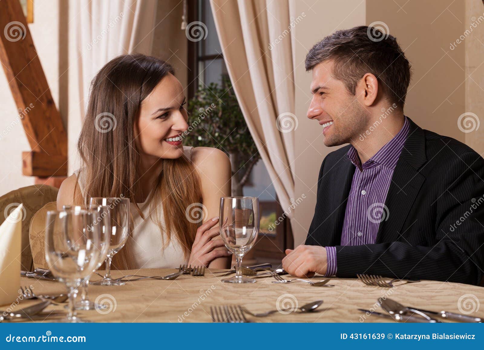 Happy couple having dinner stock image. Image of menu - 43161639