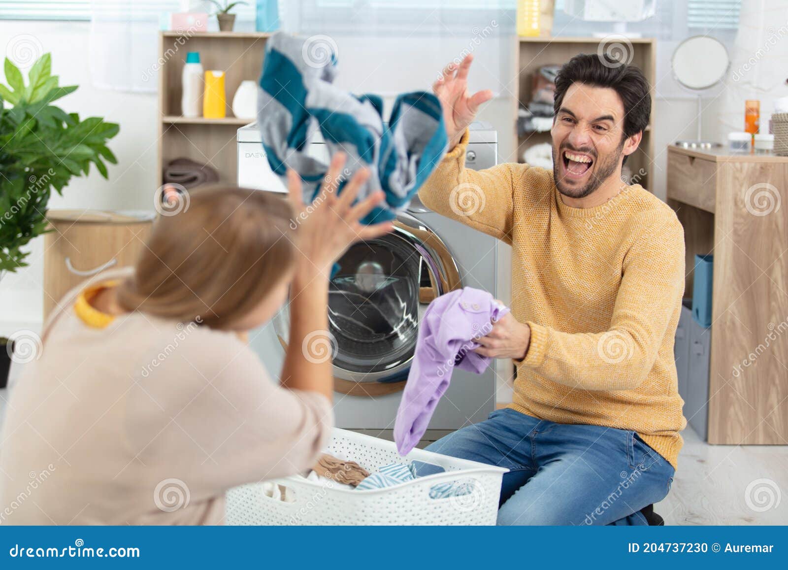 Happy Couple Having Fun Doing Laundry Together Stock Photo - Image of ...