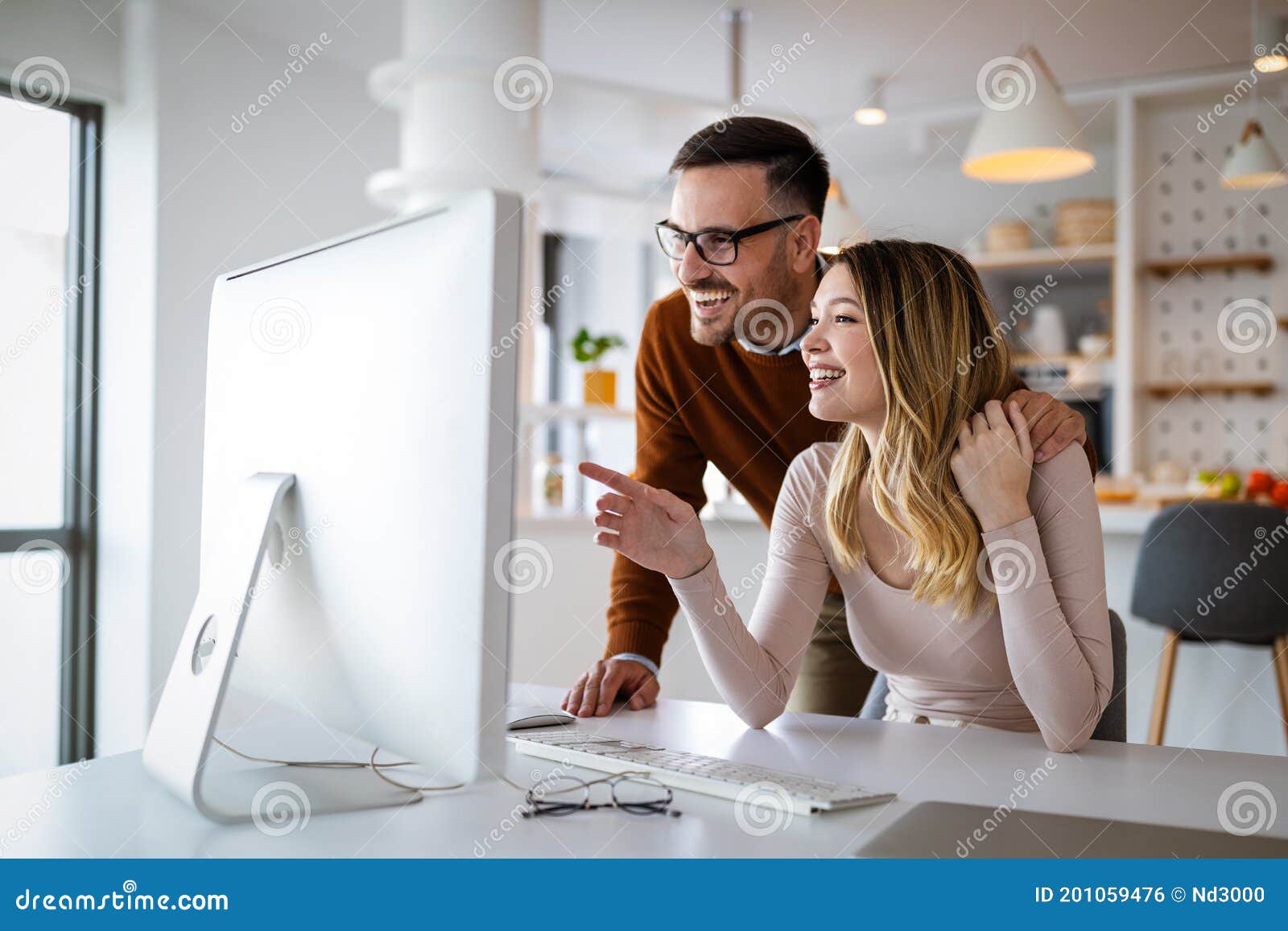 Positive Couple Having Fun while Working Together Remotely at Home ...
